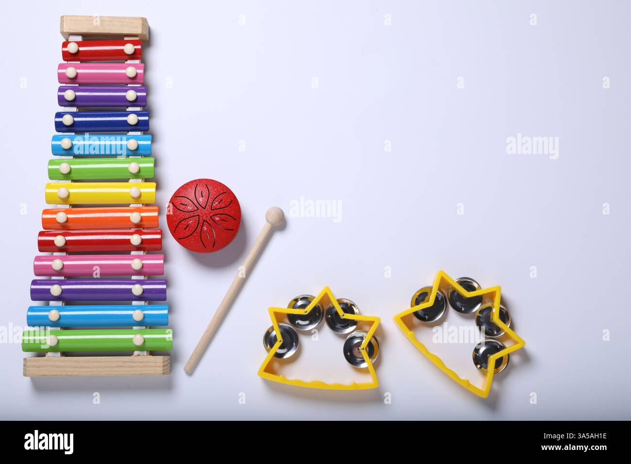 Flat lay composition with different toy musical instruments on white ...