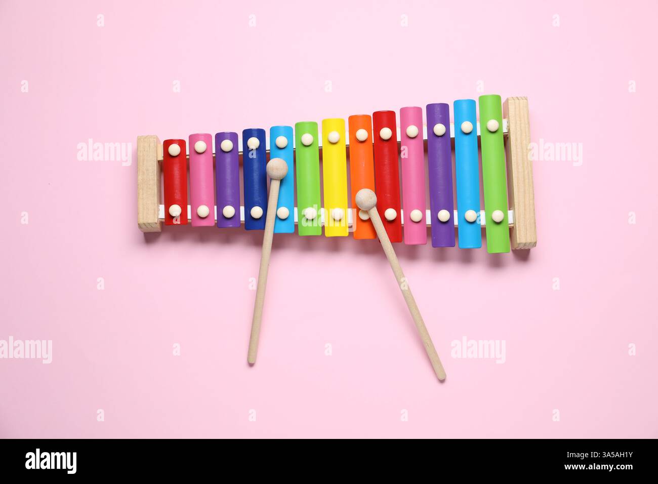 Colorful toy xylophone with mallets on pink background, top view Stock Photo - Alamy