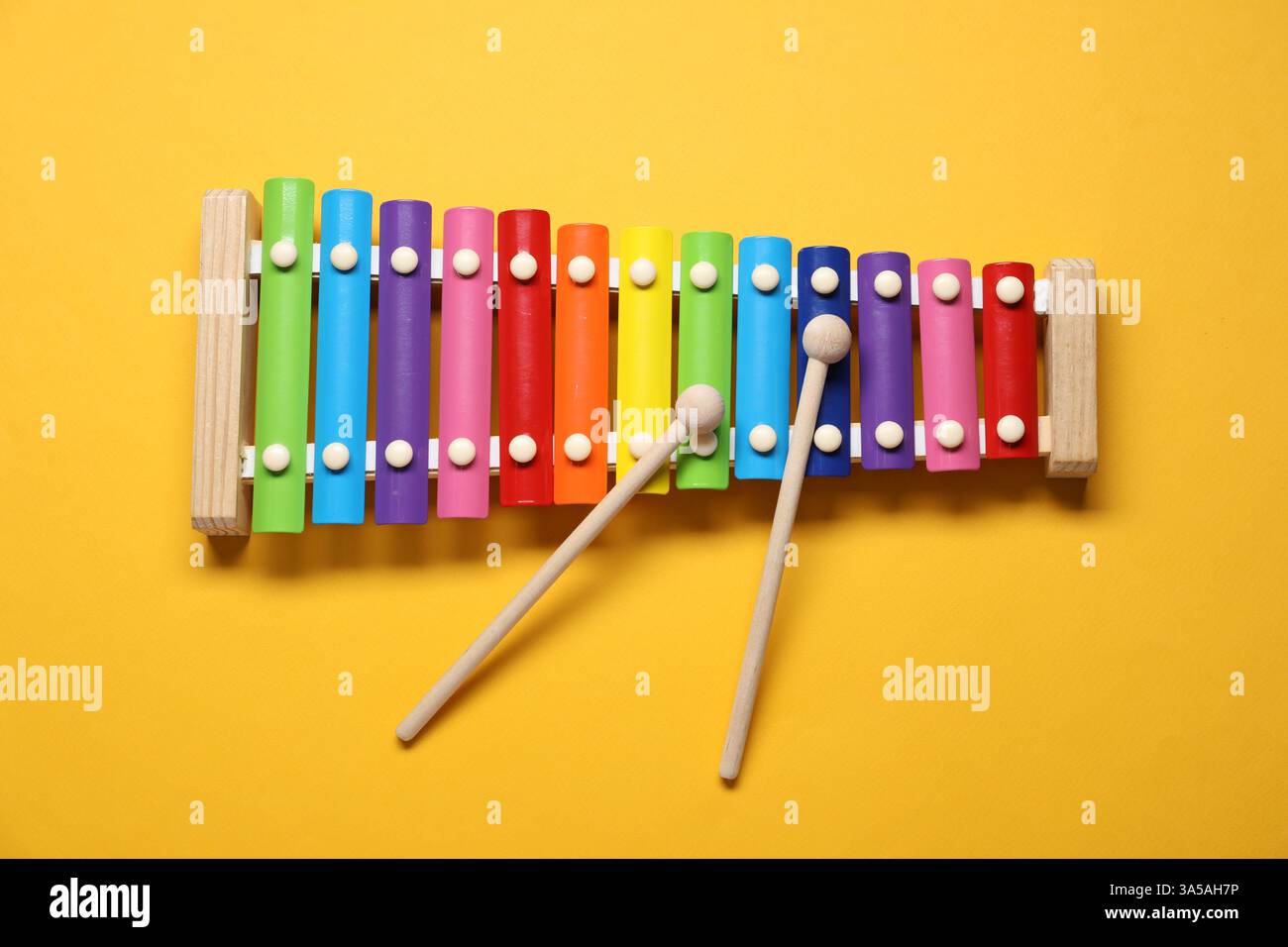 Colorful toy xylophone with mallets on yellow background, top view Stock Photo - Alamy