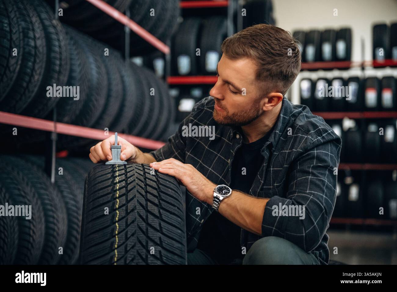 Employee is using measuring tool. Man worker is maintenance station ...