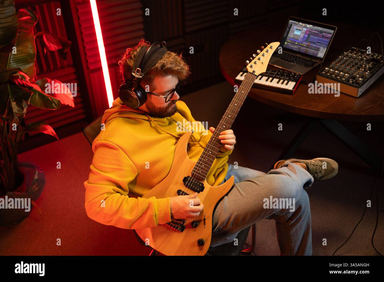 Bearded man playing electric guitar at music studio. Performance and ...