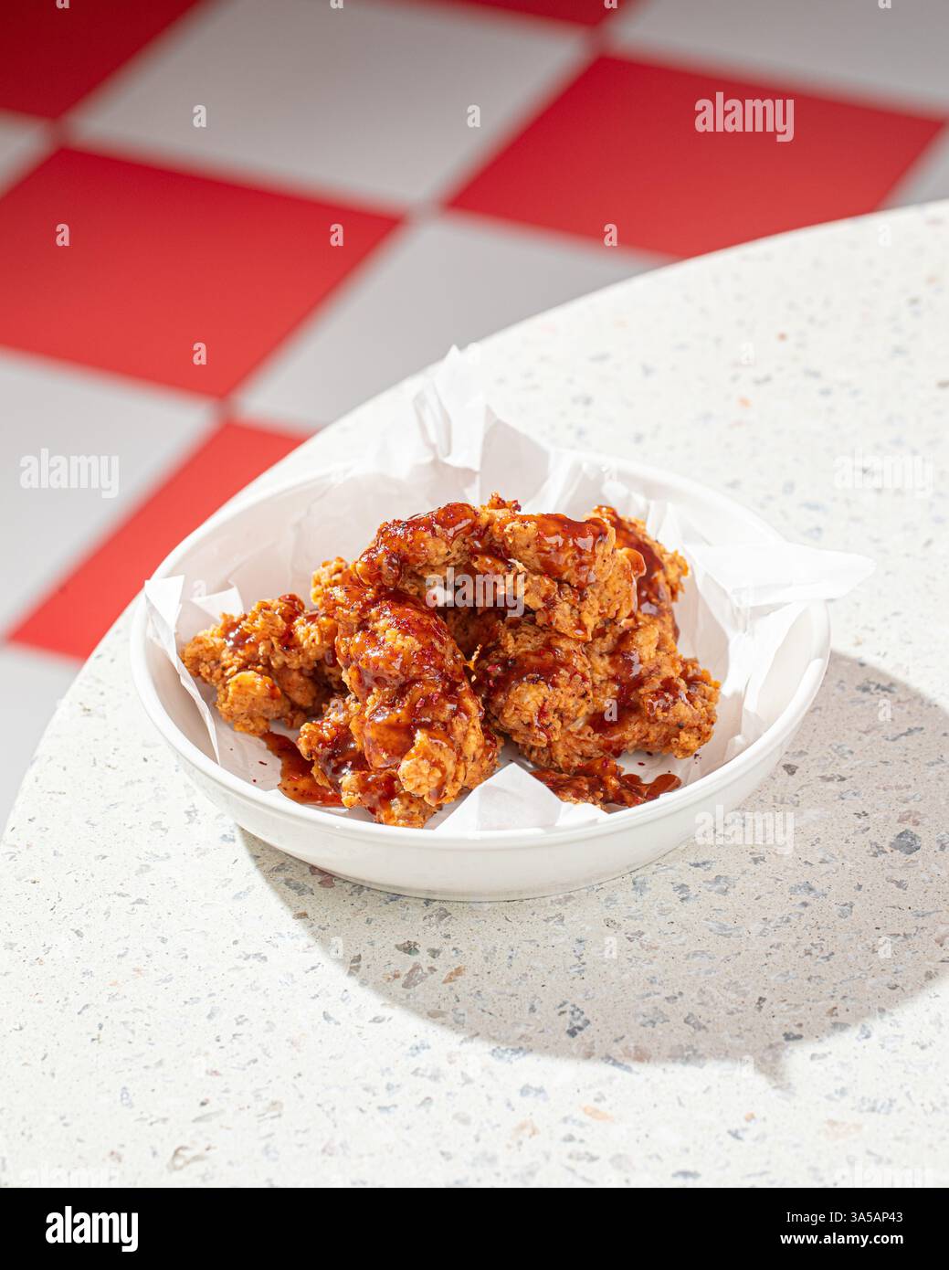 Crispy fried chicken thighs with red sauce Stock Photo - Alamy
