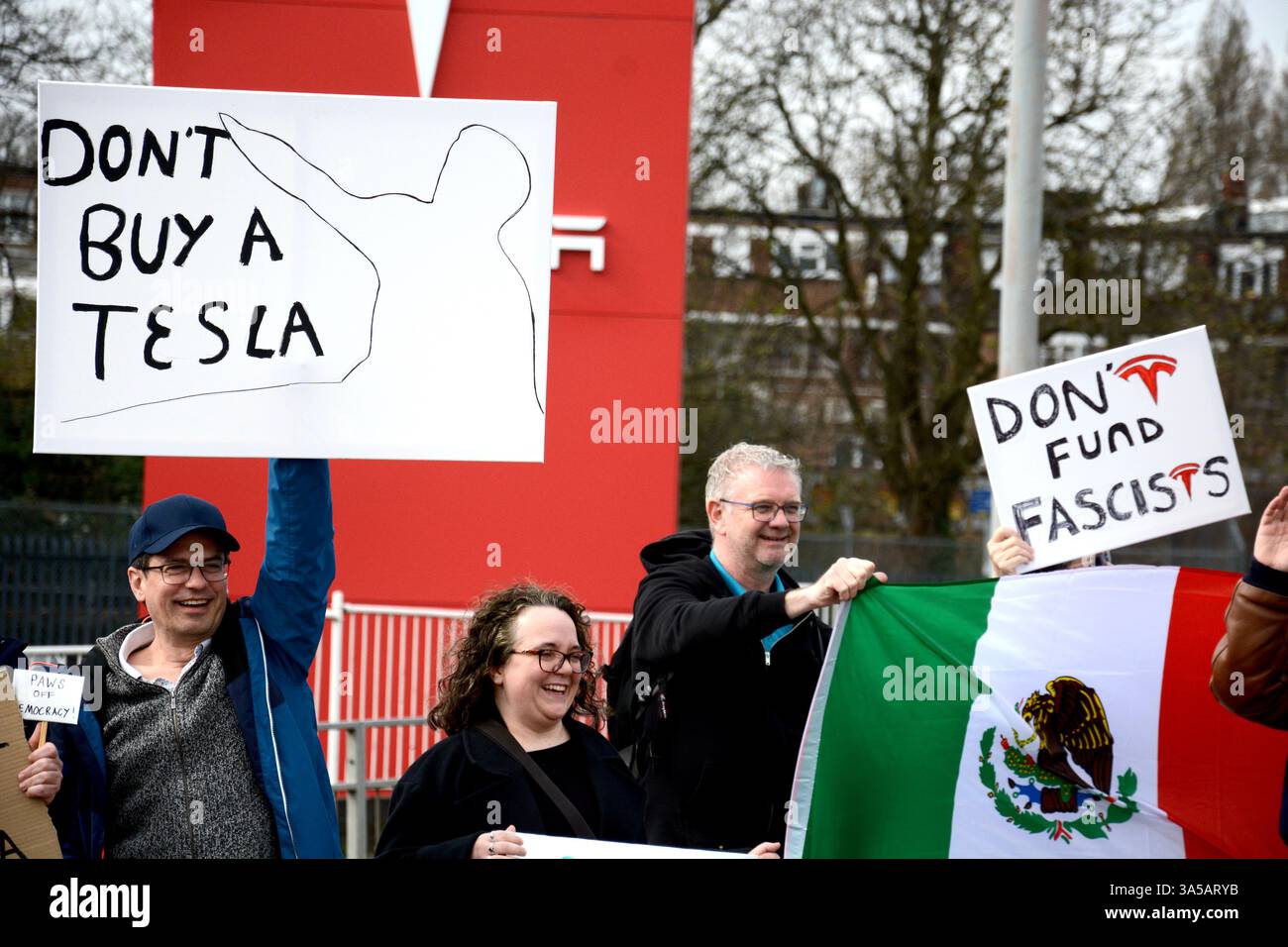 Anti Tesla demonstrators protest outside a Tesla centre showroom at ...