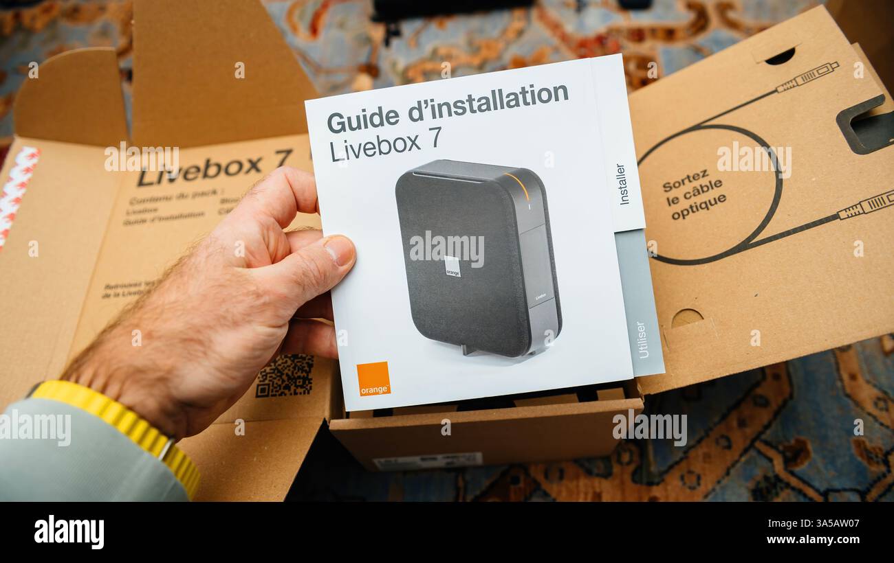 Paris, France - Feb 11, 2025: A person hand holds an installation guide ...