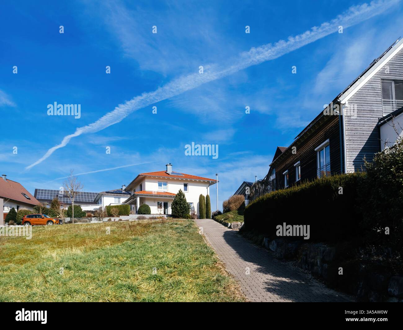 Freiburg, Germany - Mar 2, 2025: A serene suburban street under a clear ...