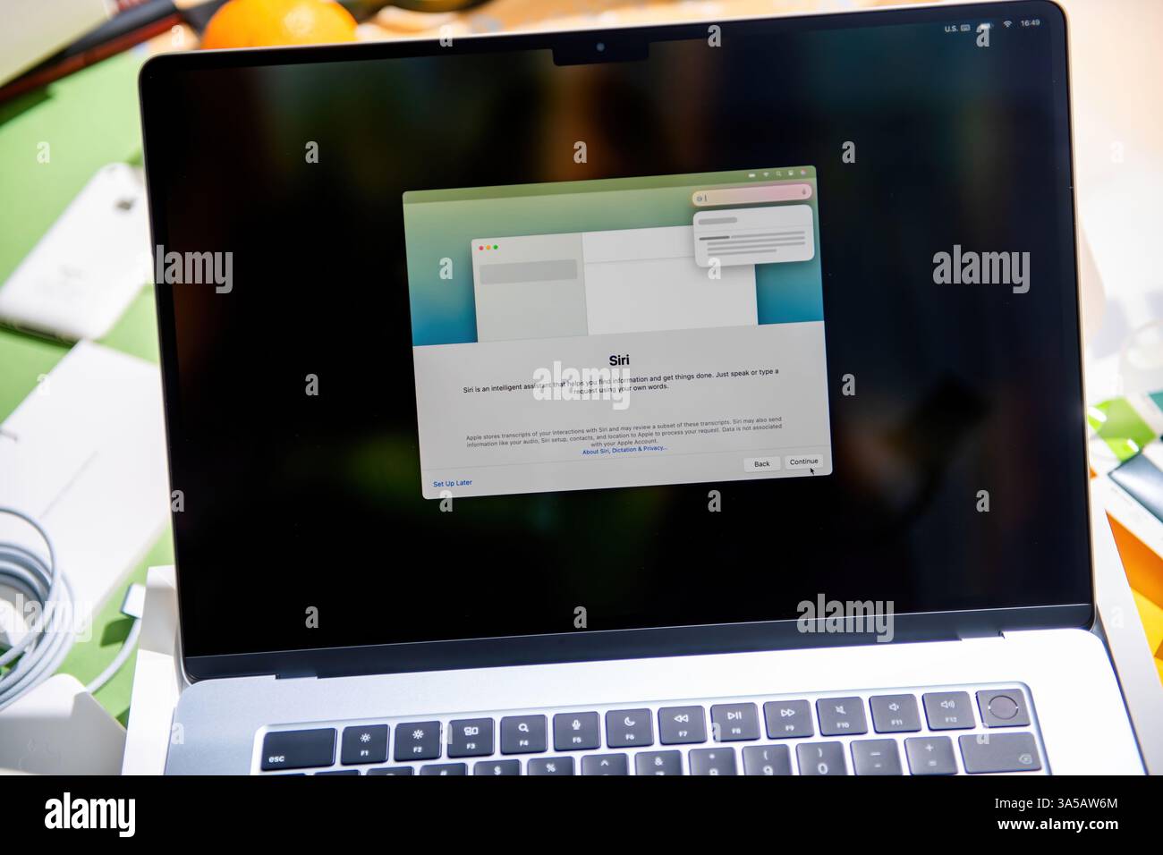 Paris, France - Mar 13, 2025: MacBook Air M4 setup screen displays Siri ...