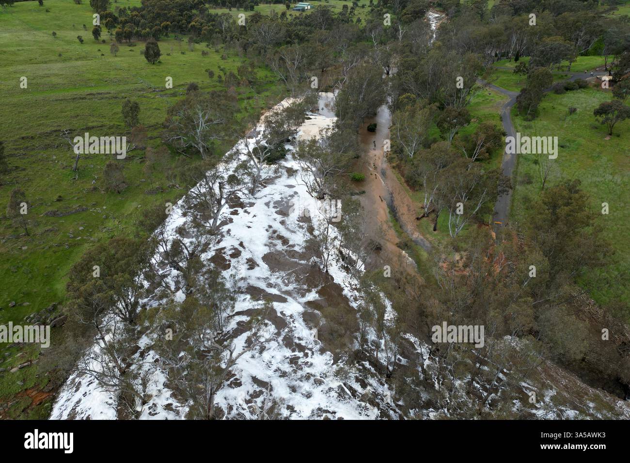 Lake Eppalock dam spillway overflowing into the Campaspe River after extreme heavy rain 2024 ...