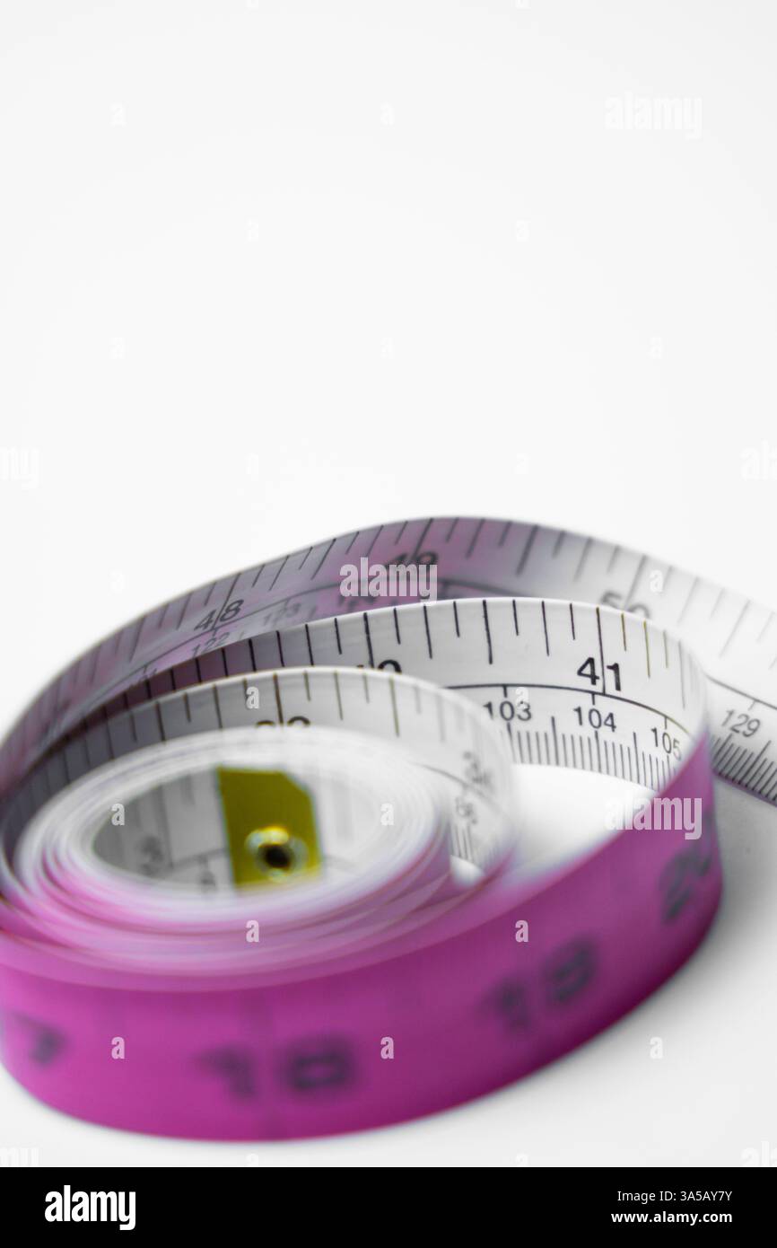 A detailed close-up shot of a measuring tape, showcasing its inch and ...