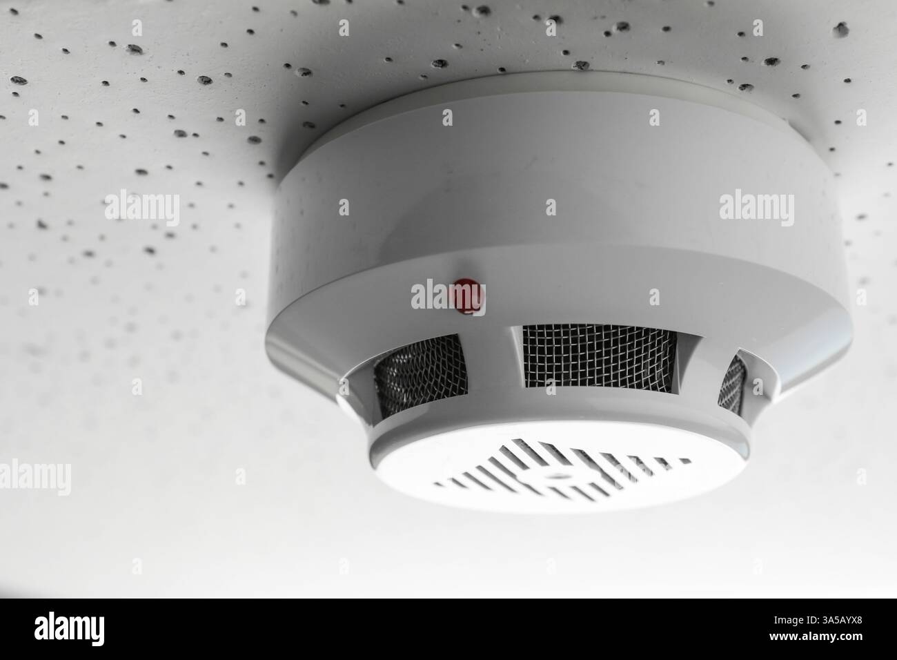 Smoke detector on light textured background, closeup. Alarm system ...