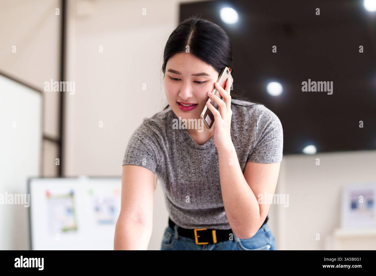 Interior designer discussing project on phone while reviewing material ...