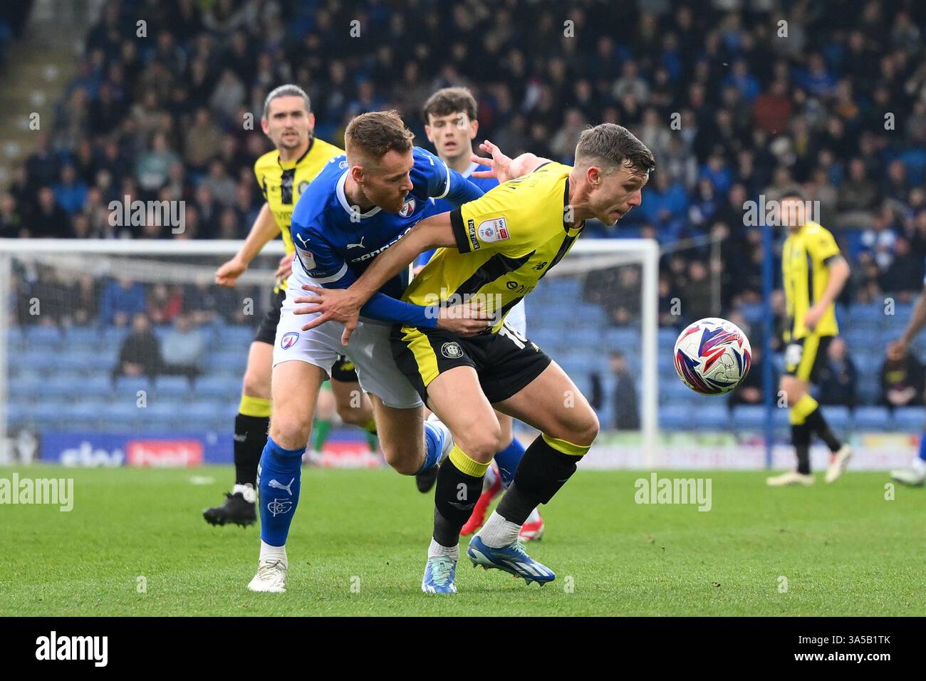 Tom Naylor of Chesterfield battles with Jack Muldoon of Harrogate Town ...