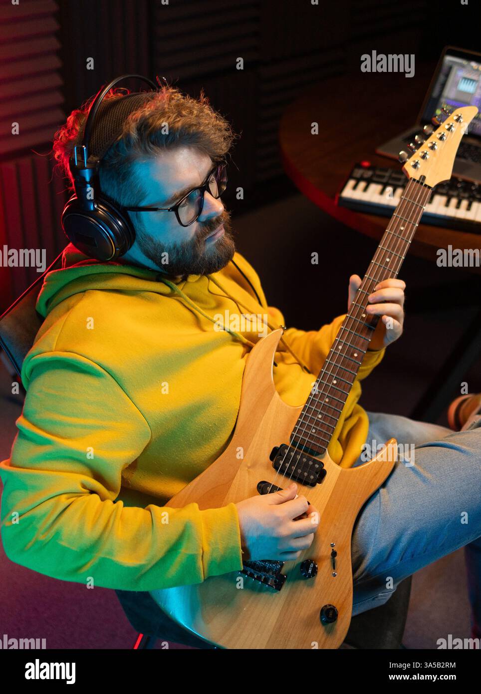 Man vocal artist singing in a recording studio with guitar. Male singer ...