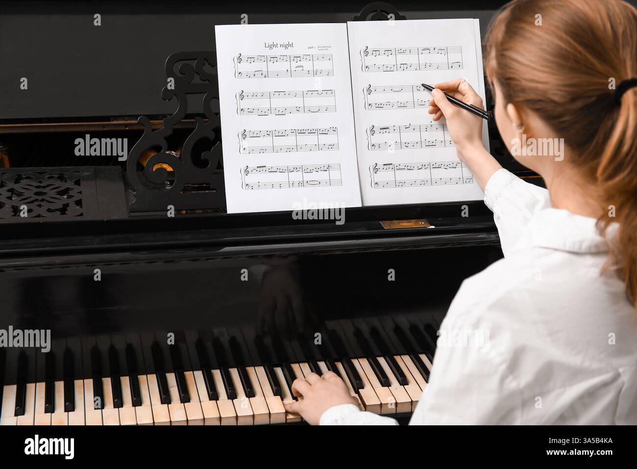 Woman playing piano and writing notes, closeup Stock Photo - Alamy