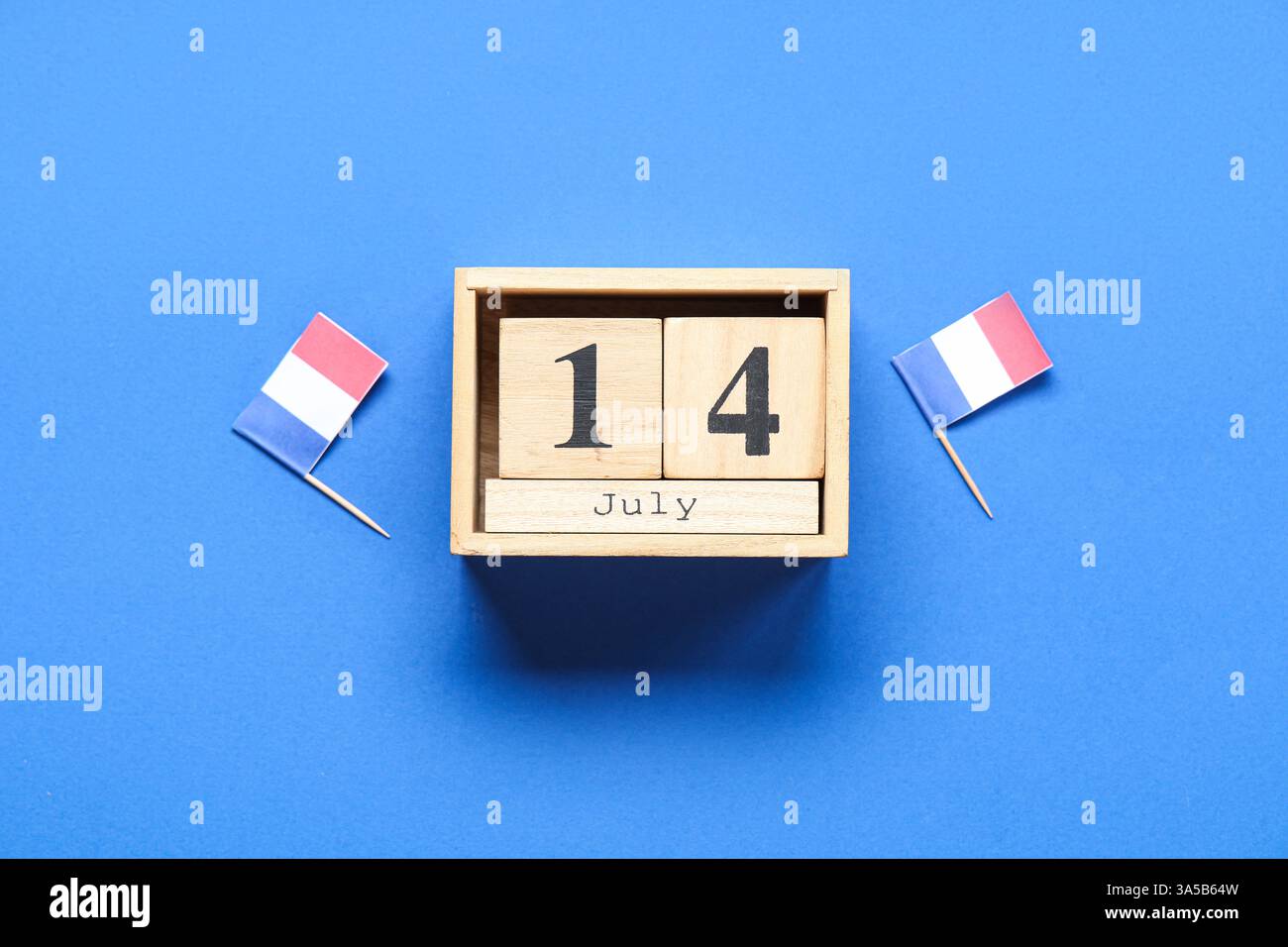 Cube calendar with date 14 JULY and flags of France on blue background ...