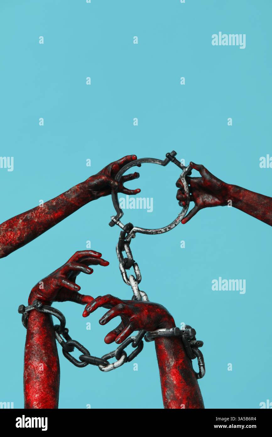 Many hands of zombies with chains on blue background. Halloween ...