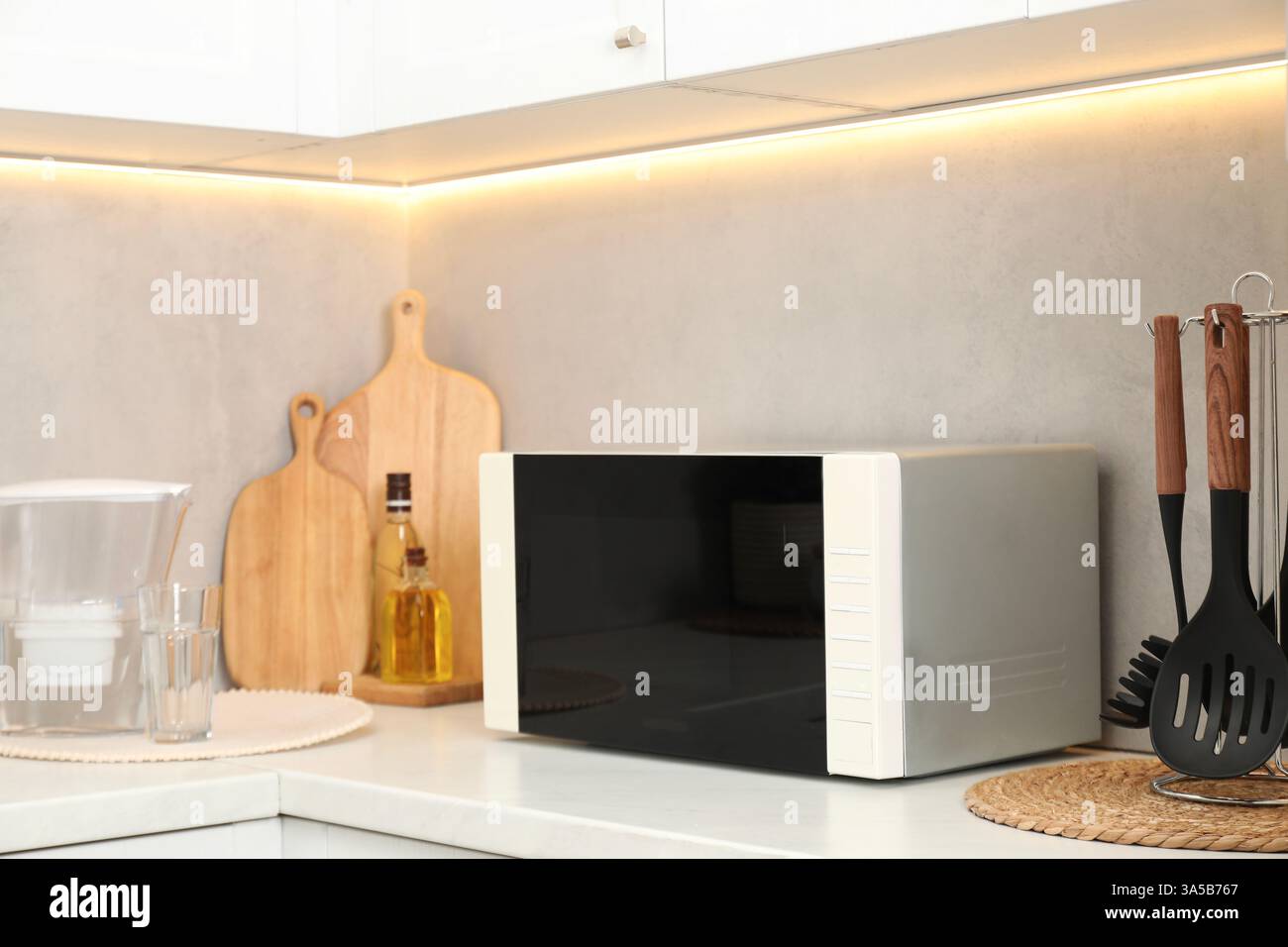 Closed microwave oven on counter in kitchen Stock Photo - Alamy