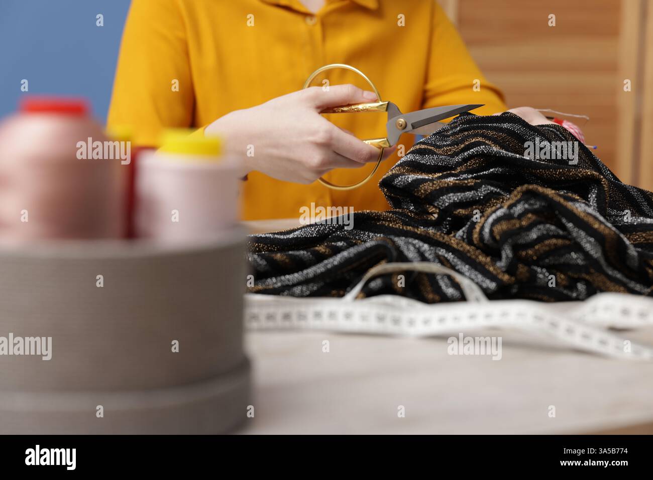 Woman cutting cloth light hi-res stock photography and images - Alamy