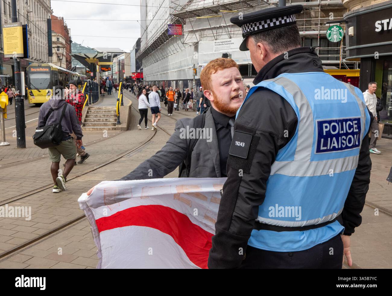A single counter protester carrying an English flag marked with 'Free ...