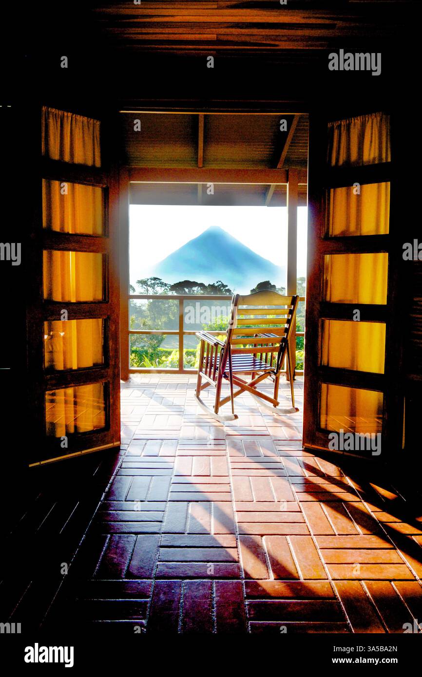 two beautiful wooden glass doors opening out onto a balcony with a ...
