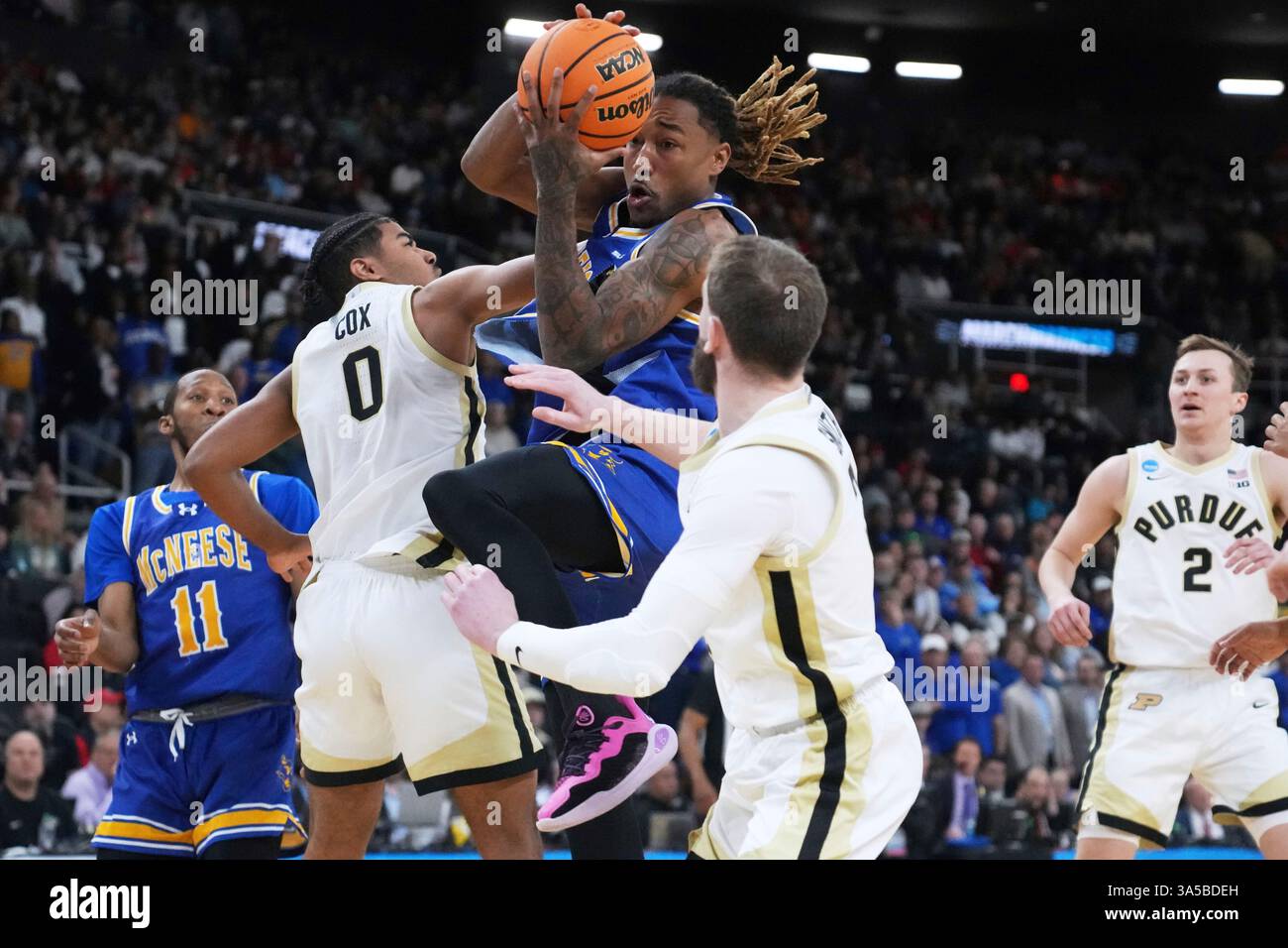McNeese State forward Christian Shumate, center, is covered by Purdue's ...