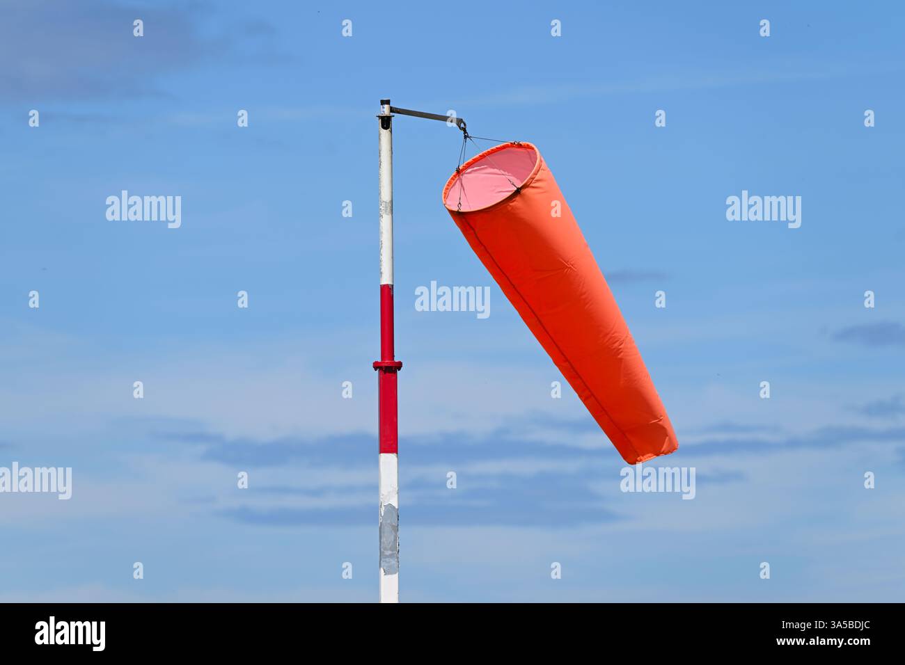 Red windsock on red and white striped pole at Papa Westray airfield ...
