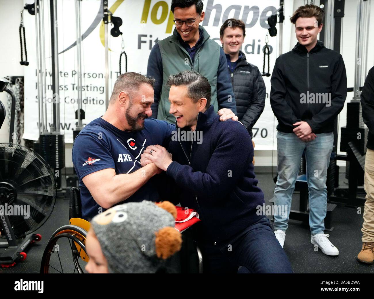 Conservative Leader Pierre Poilievre greets Peter Morel, an adaptive ...