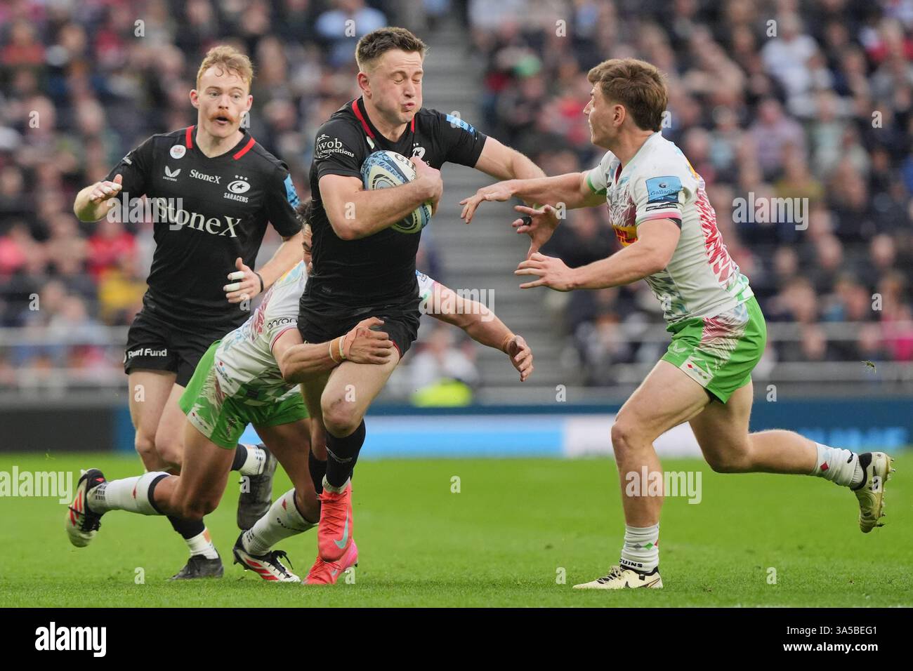 Saracens’ Fergus Burke (centre) is tackled by Harlequins’ Nick David ...
