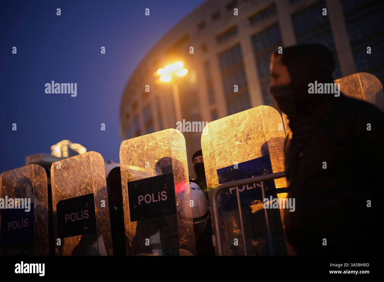 Riot police stand guard during a protest against the arrest of Istanbul ...