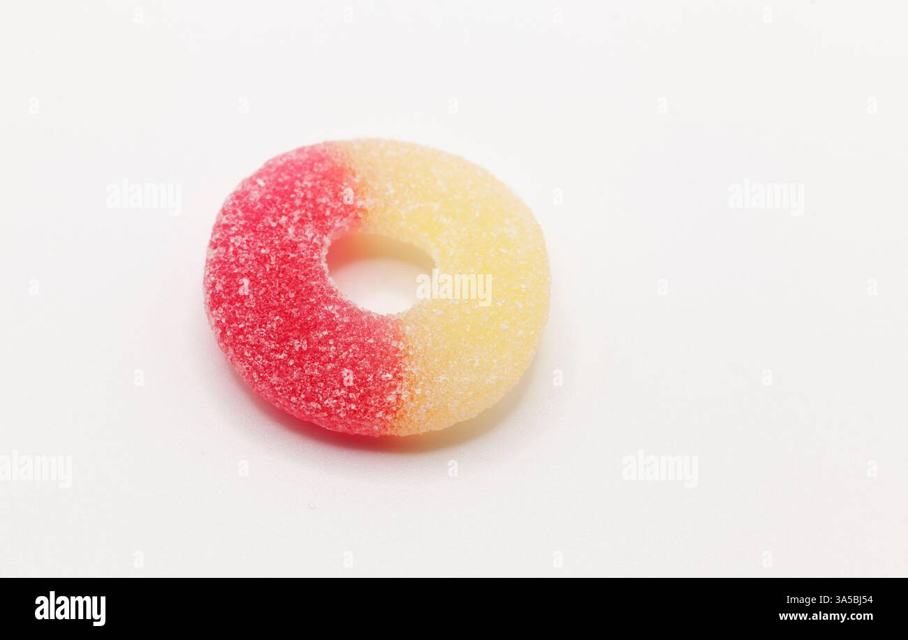 A peach-shaped gummy or jelly candy with a gradient from red to white ...