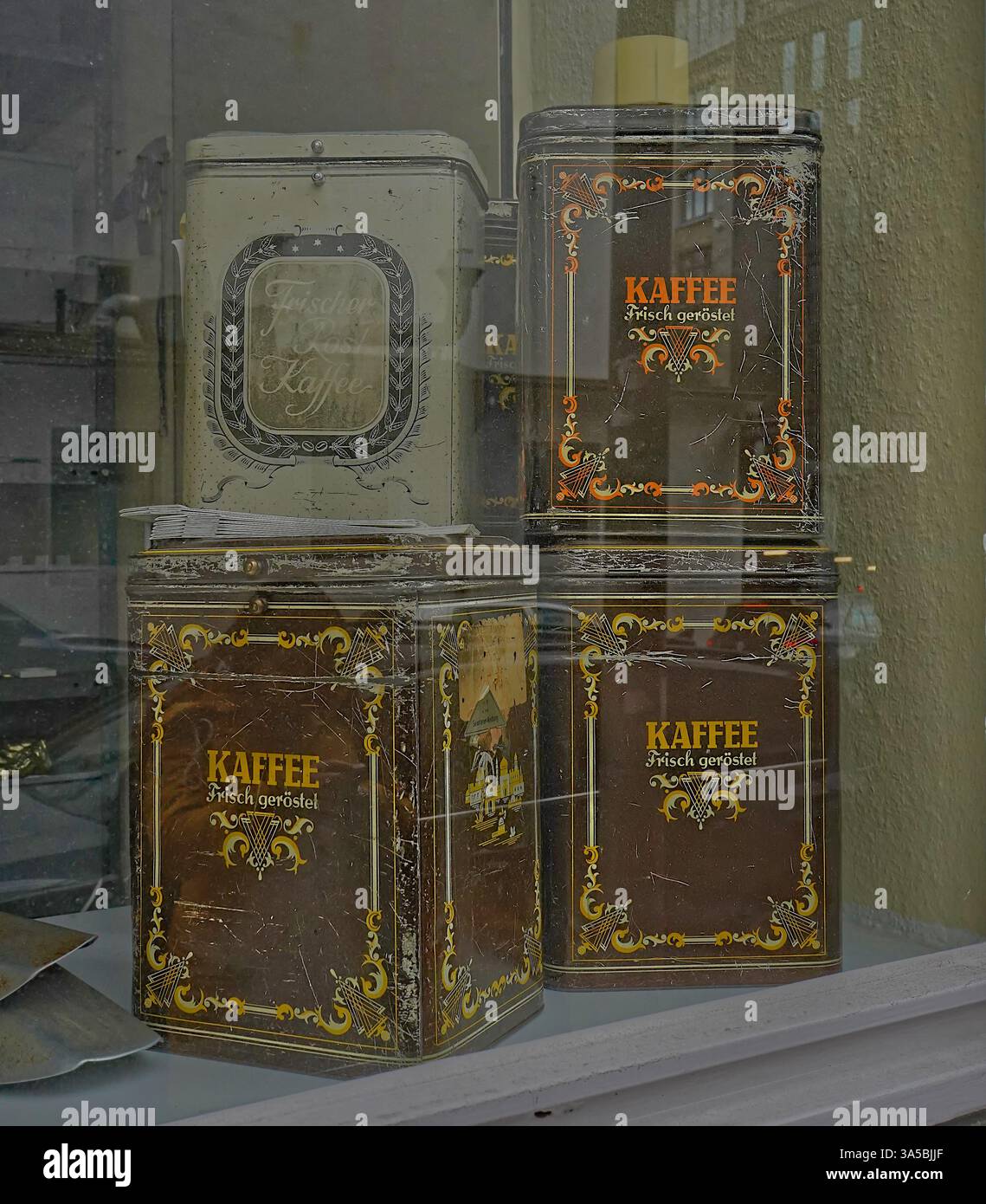 Vintage boxes serving as the storage for coffee seen through a glass ...
