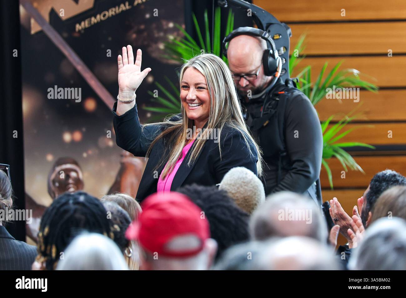 Minneapolis, Minnesota, USA. 22nd Mar, 2025. Kristy Wendell waves ...