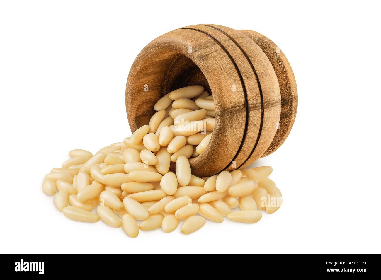 Shelled European pine nuts in wooden bowl isolated on white background ...