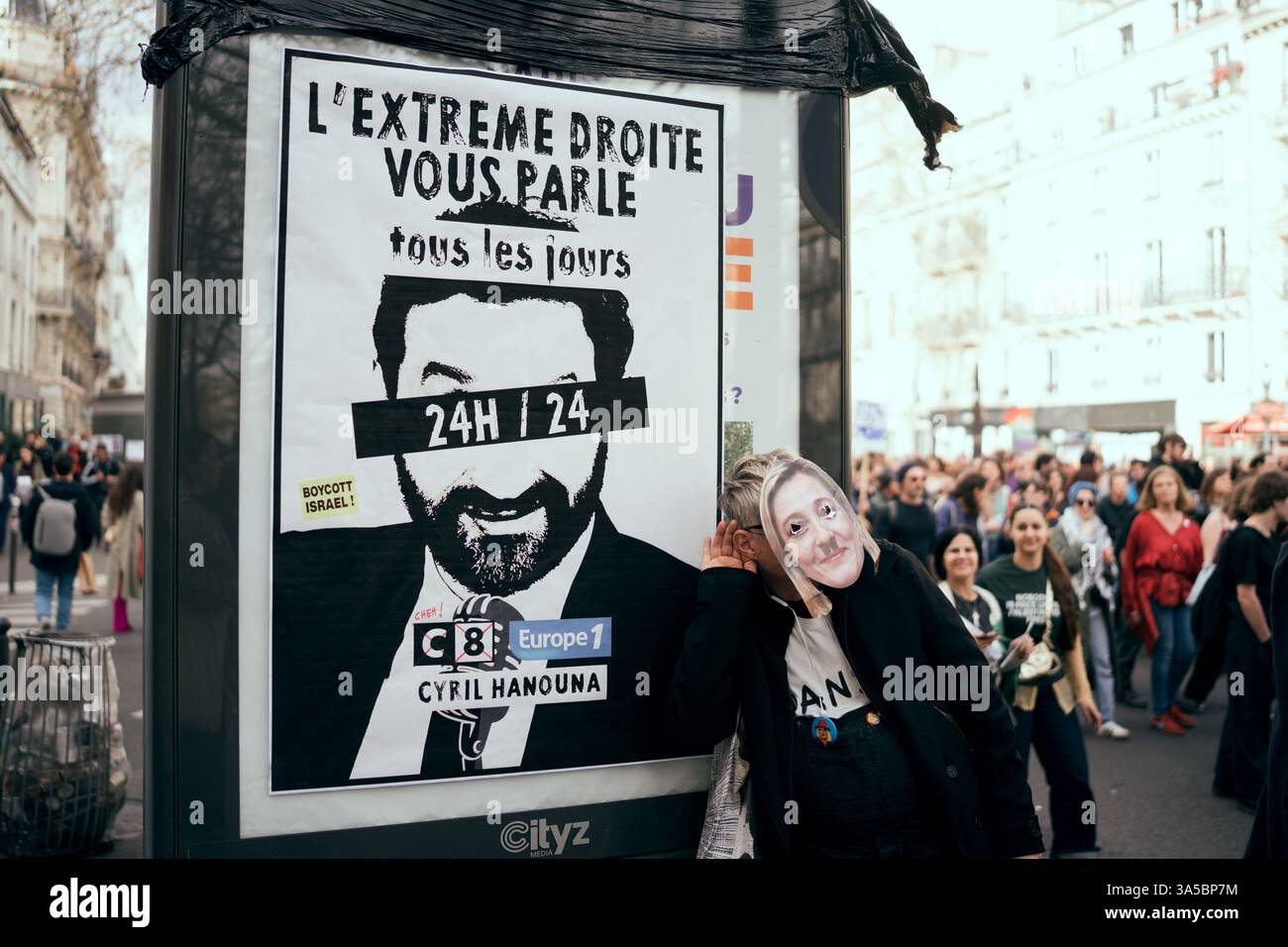 This photo shows a poster with a portrait of Cyril Hanouna and the ...