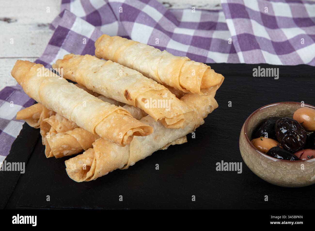 Cigarette pastry. Cheese pie on wood floor. Fried cheese rolls with ...