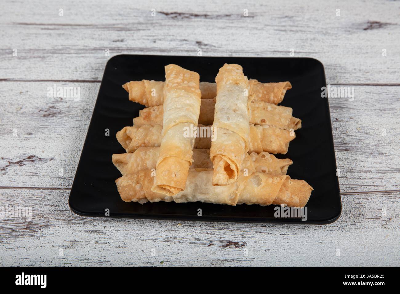 Cigarette pastry. Cheese pie on wood floor. Fried cheese rolls with ...