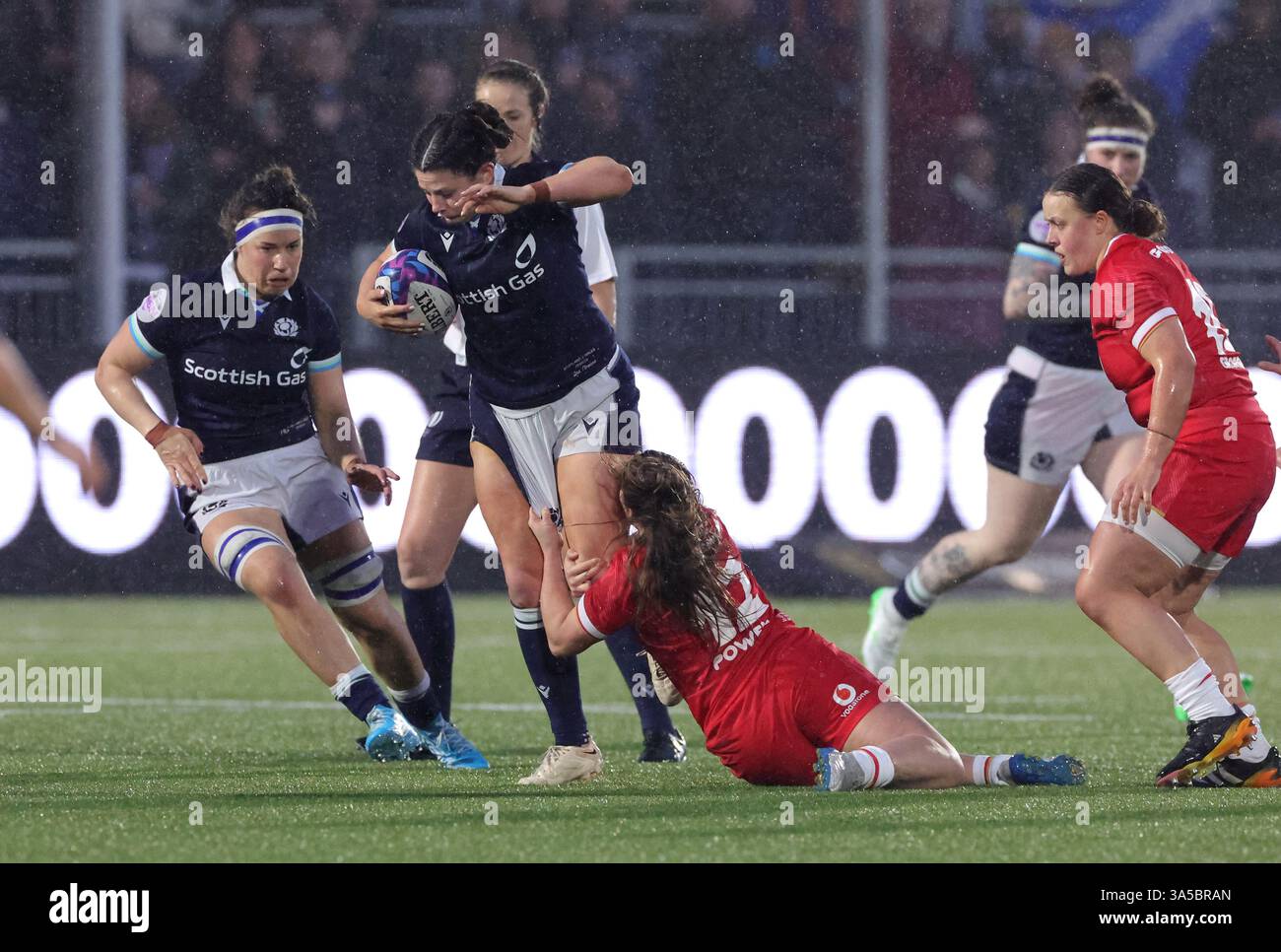 Scotland's Lisa Thomson is tackled by Wales' Kayleigh Powell during the ...