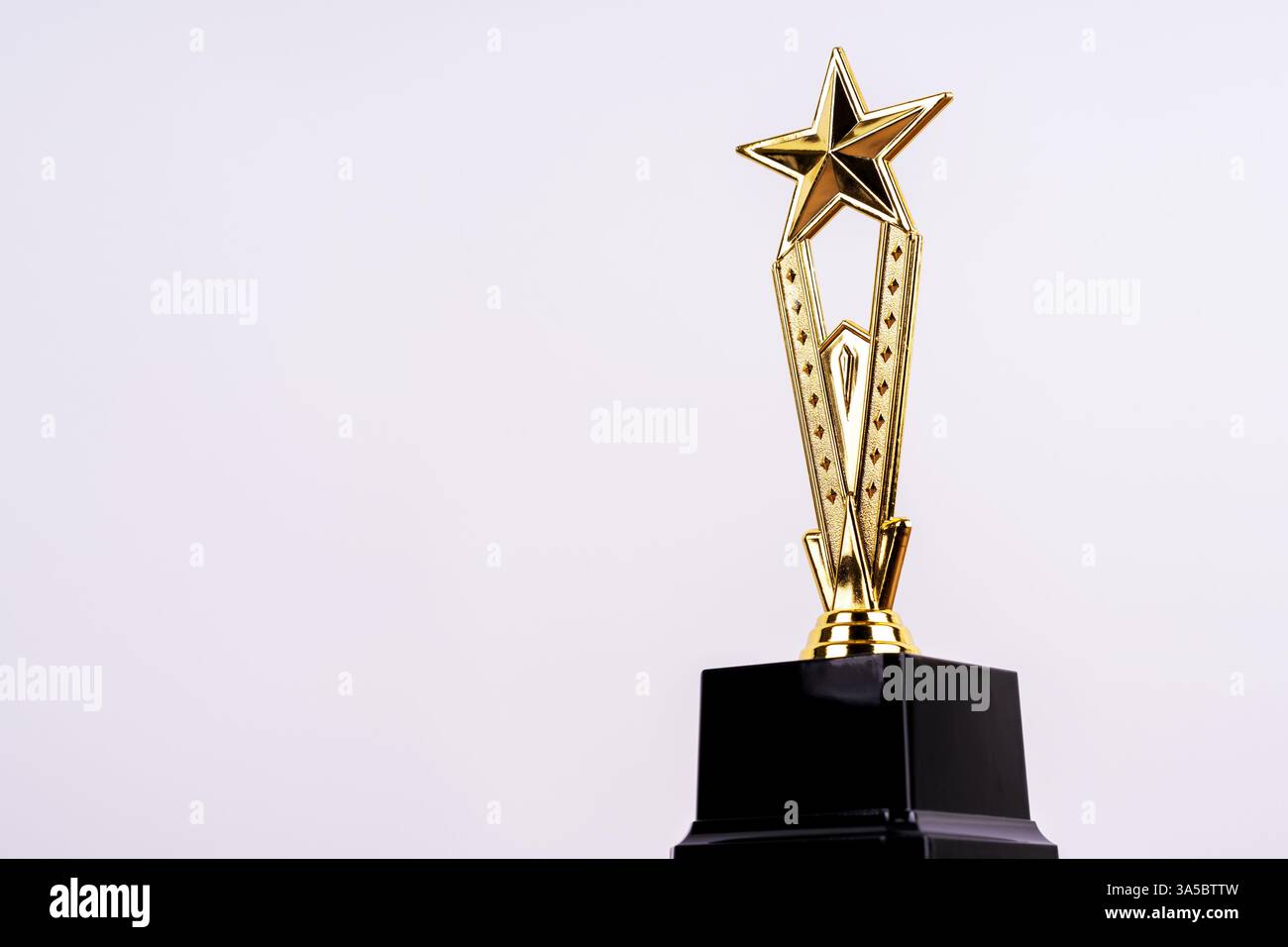 Gold trophy with start shape on white background Stock Photo - Alamy