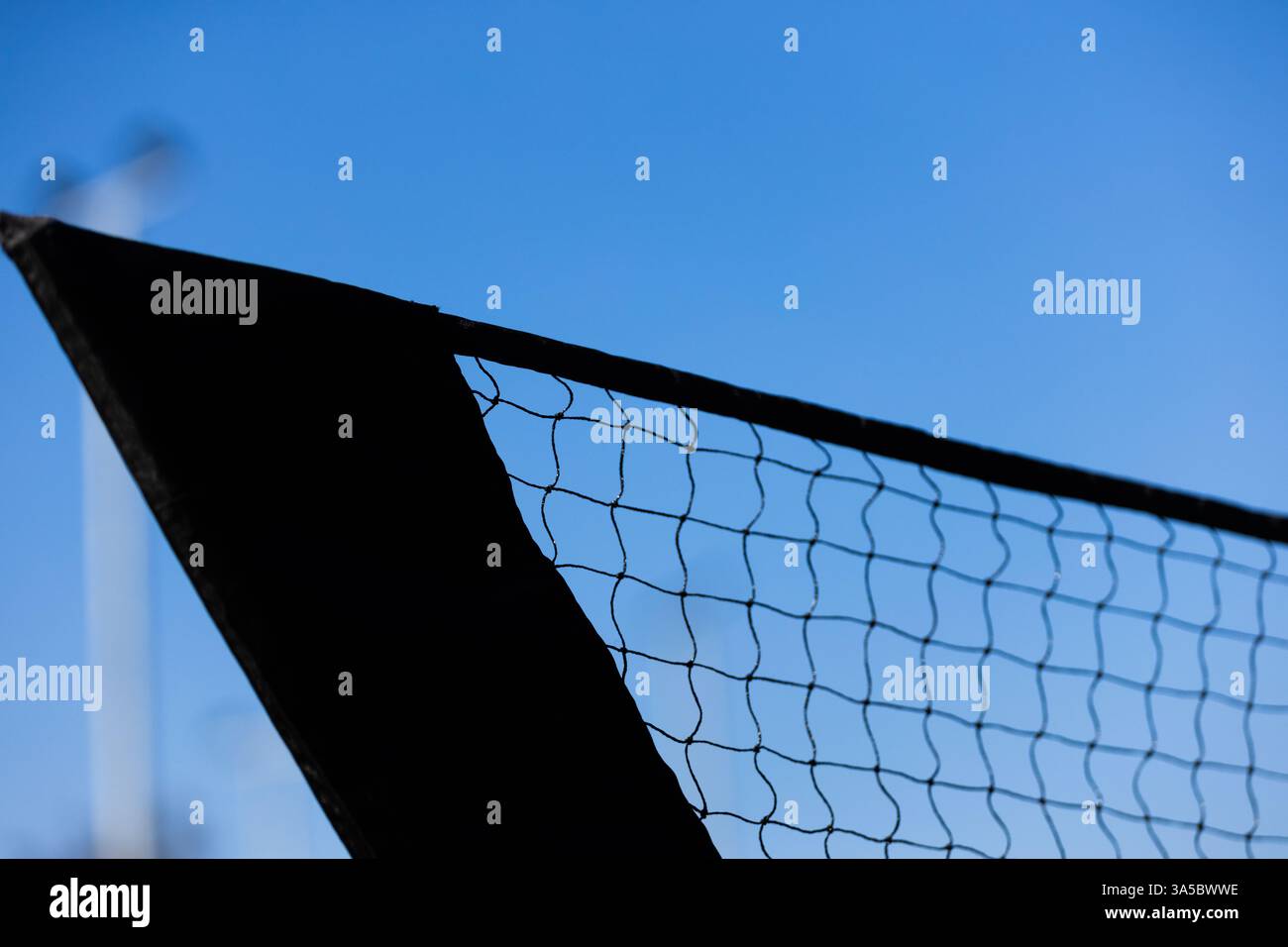 A Close-Up View of a Sports Net Against a Clear Blue Sky Showcasing the Interwoven Structure and ...