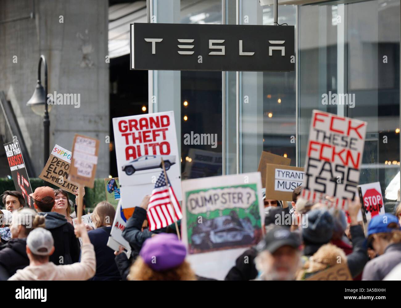 New York, United States. 22nd Mar, 2025. Protesters hold signs when ...