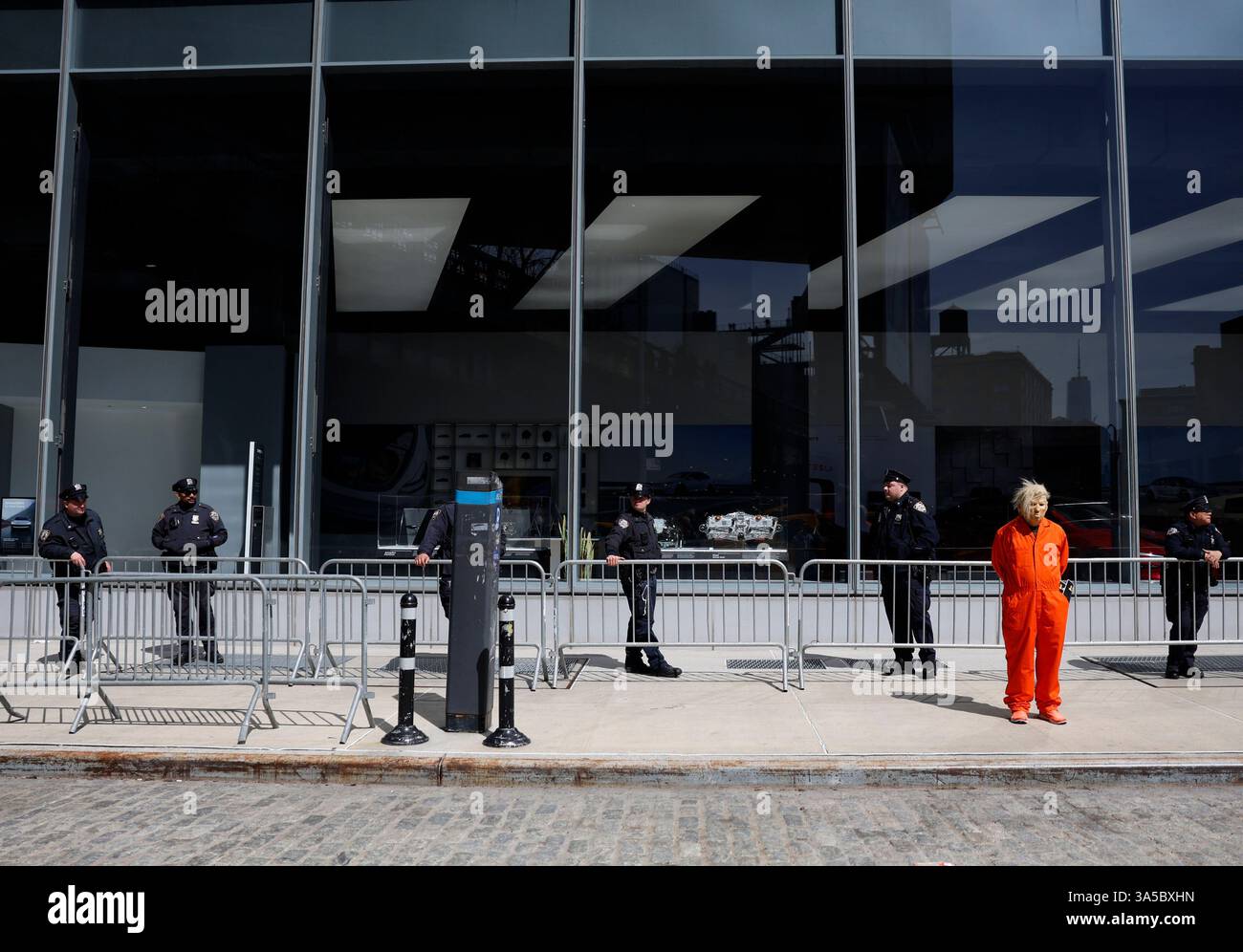 NYPD Police officers protect the area around the Tesla Dealership as ...