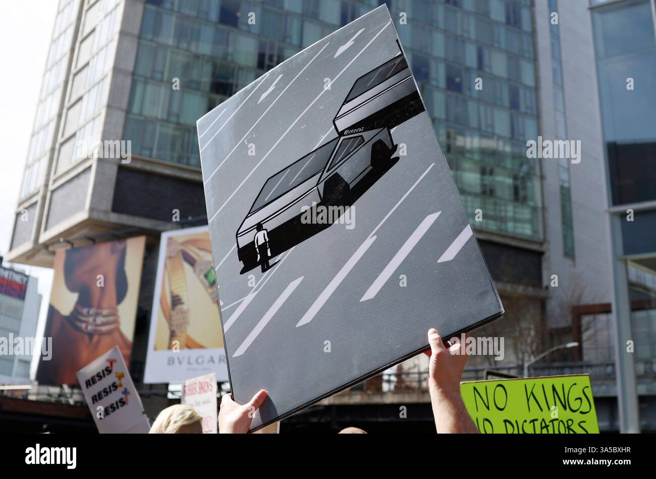 New York, United States. 22nd Mar, 2025. Protesters hold signs when ...