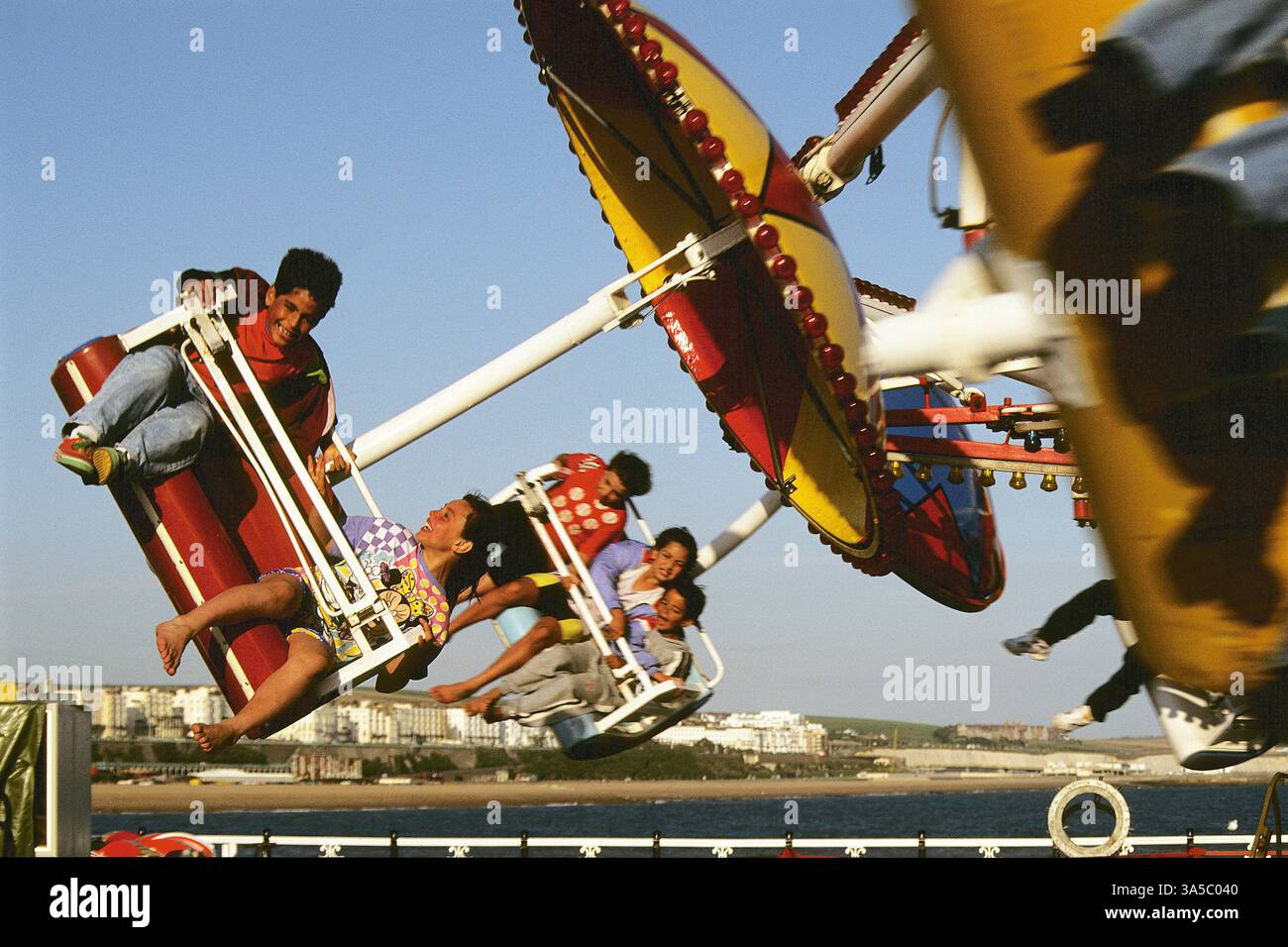 Fast fairground ride with young people Stock Photo - Alamy