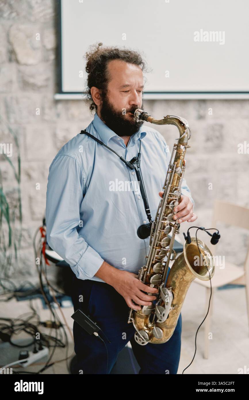 USA, Boston - March 15, 2024: Saxophonist plays the saxophone on stage ...