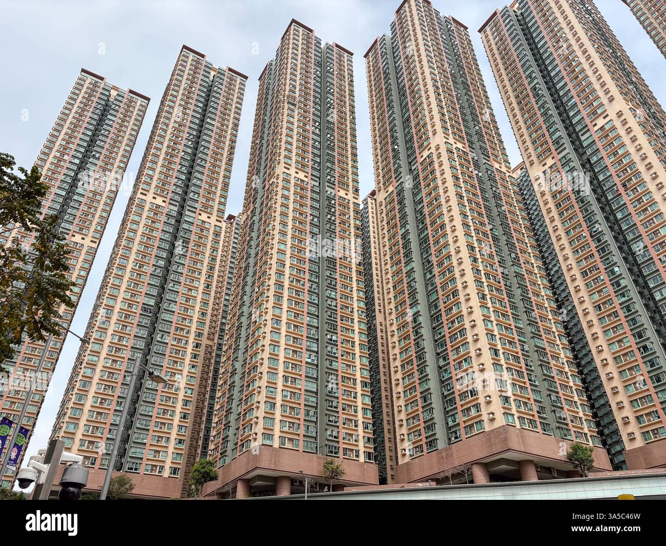 A cluster of extremely tall residential buildings in Hong Kong, showing the city's high ...