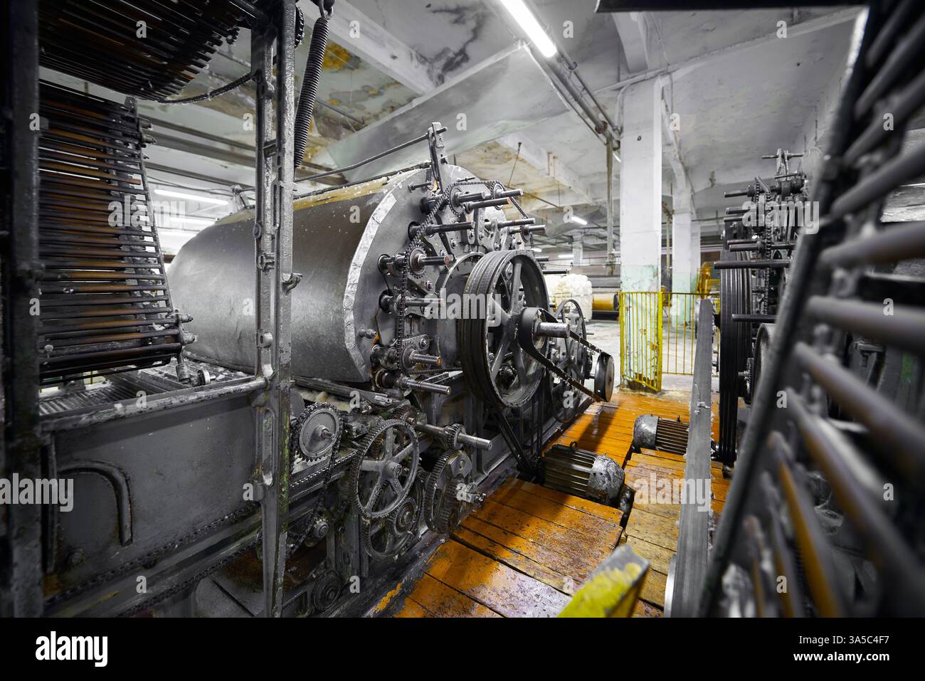 Vintage carding machine in a dimly lit factory showcasing the ...
