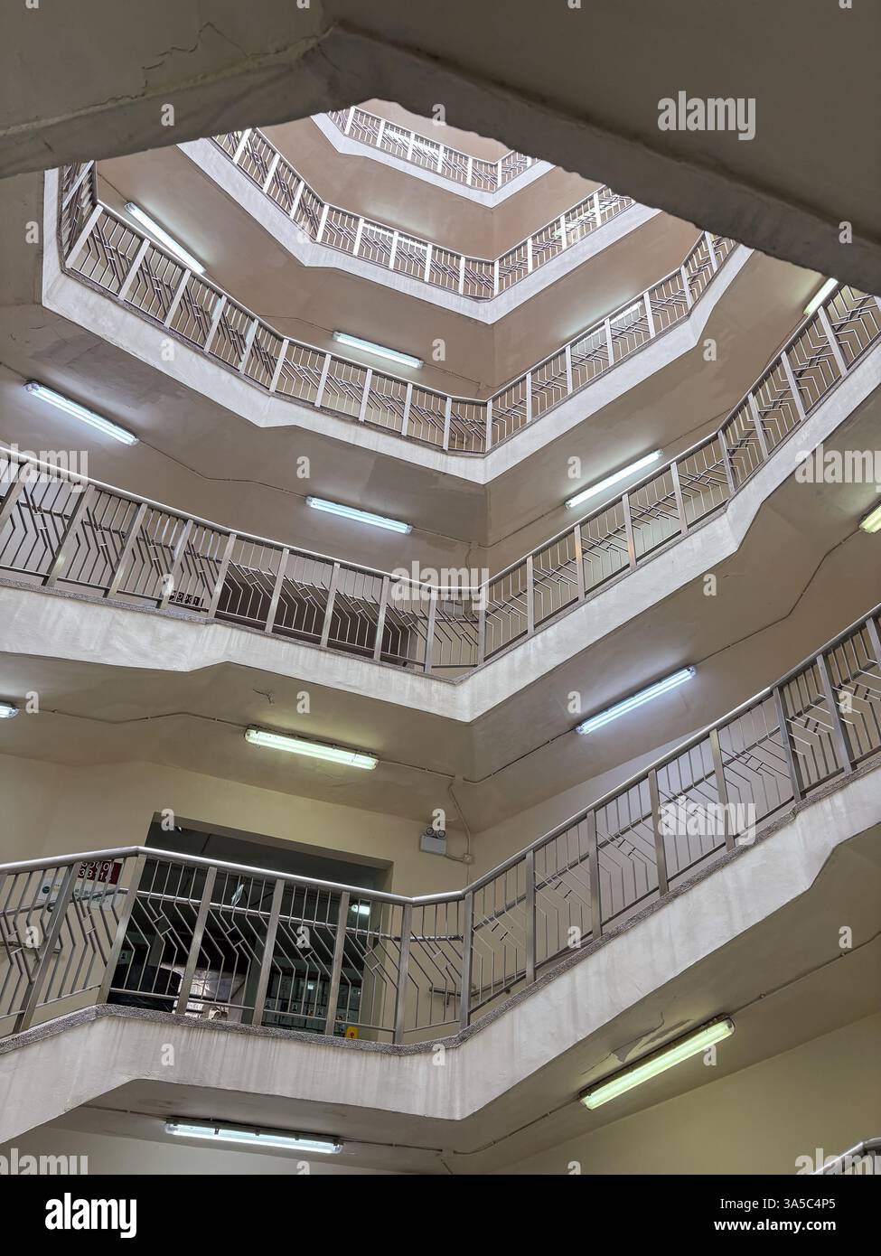 Interior view of an apartment building staircase atrium, showing ...