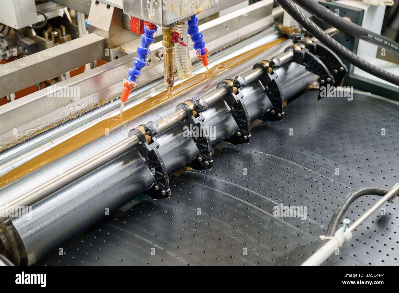 Efficient glue applicator in action during an automated manufacturing ...