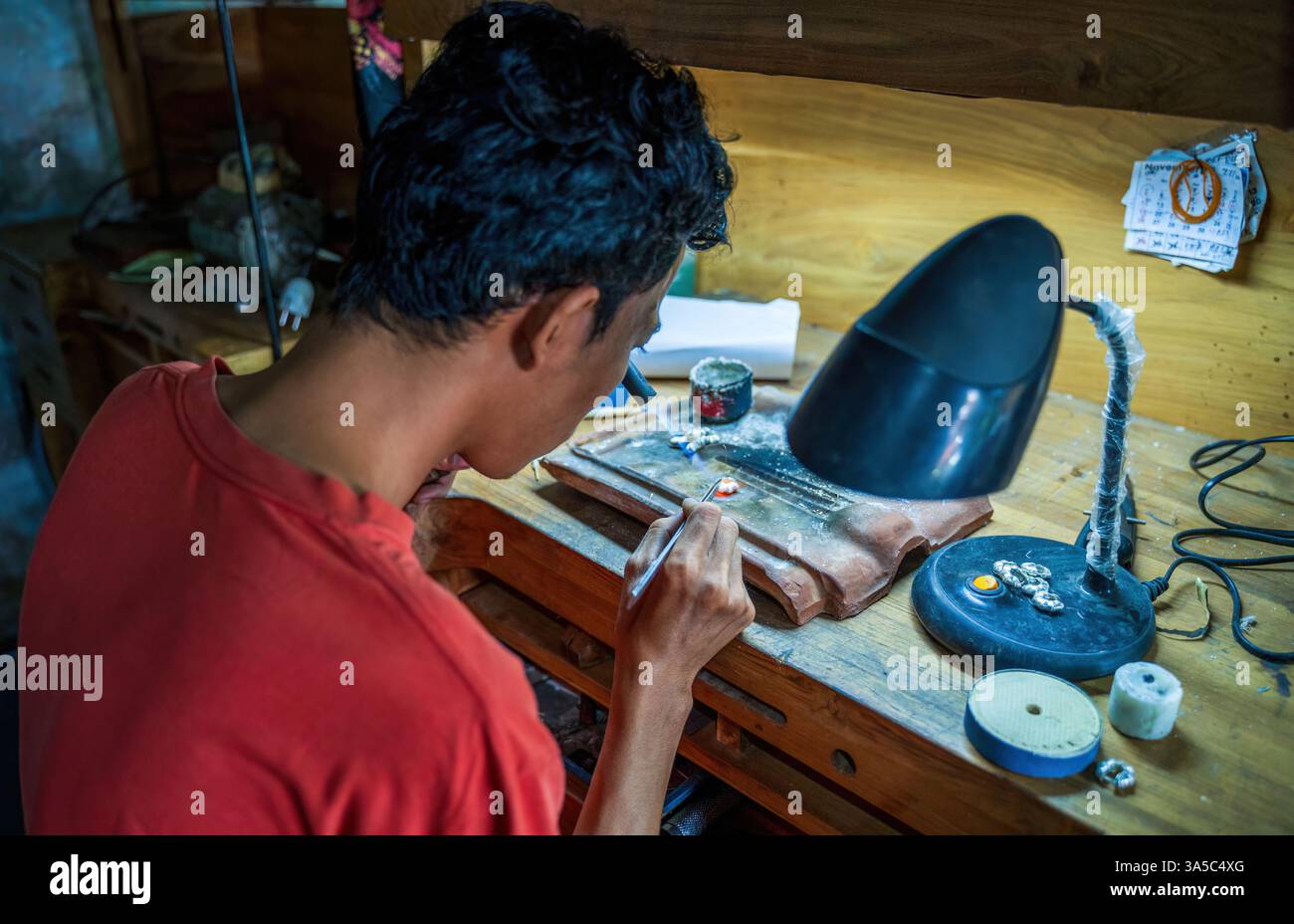Bali, Indonesia - March 22, 2025: Artisan skillfully working at a well ...
