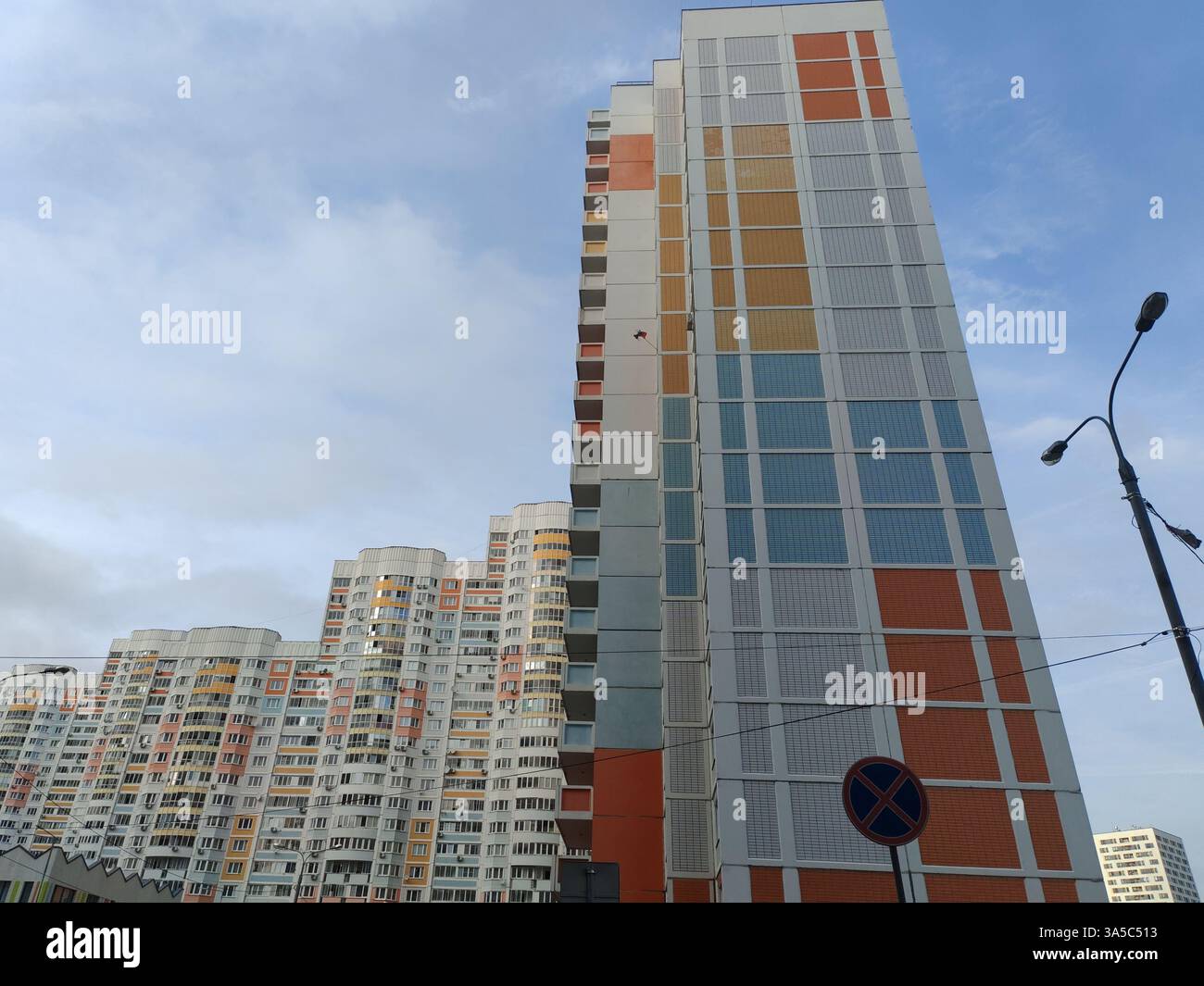 A large multi-story residential building with a pastel color palette of ...