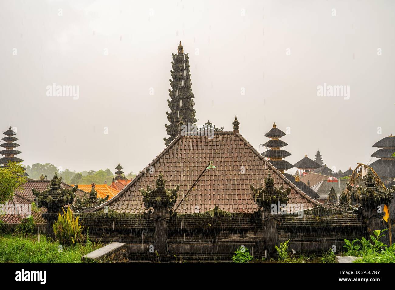 Balinese temple towers rise through the misty rain, creating a mystical ...